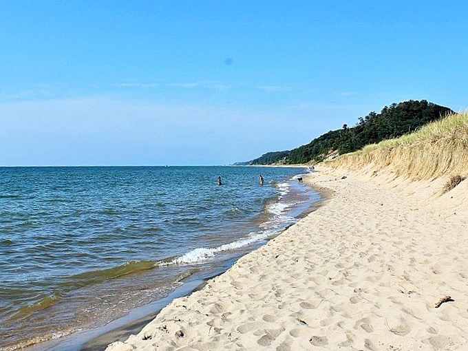 The reward for your hiking efforts: pristine sandy shores meeting Lake Michigan's crystal waters, where time seems to slow down.