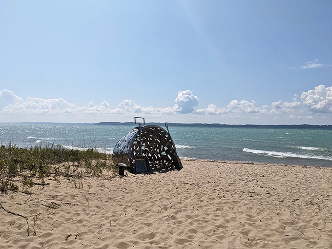 "Singing Pail of Dreams" sits like a mysterious sentinel on the beach, framing Lake Michigan's vastness through artistic perspective.