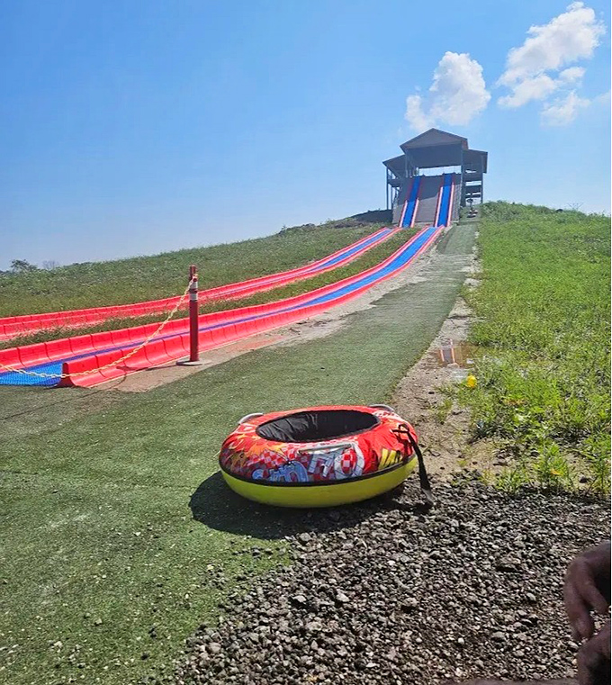 The Super Mega Slide stands tall against the sky, daring visitors to climb up for that brief moment of weightlessness before gravity takes over with delightful consequences.