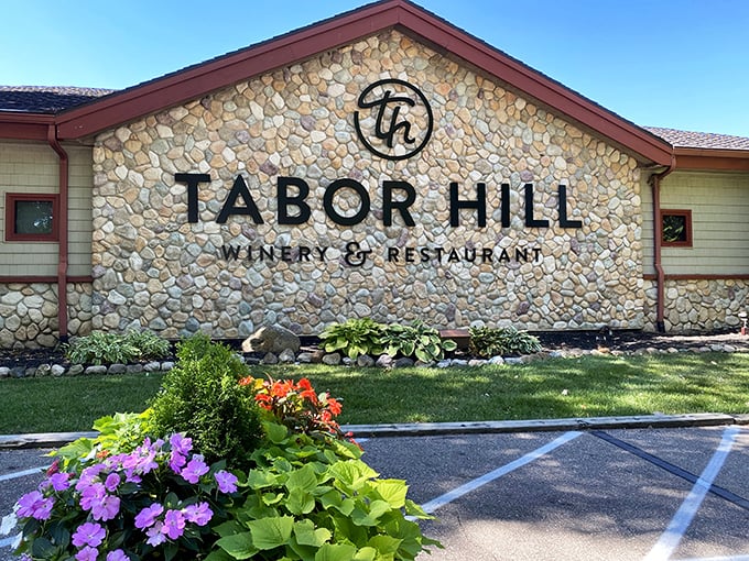 Tabor Hill Winery's stone facade stands like a welcoming beacon after your forest trek, promising cool respite and delicious rewards for tired hikers.