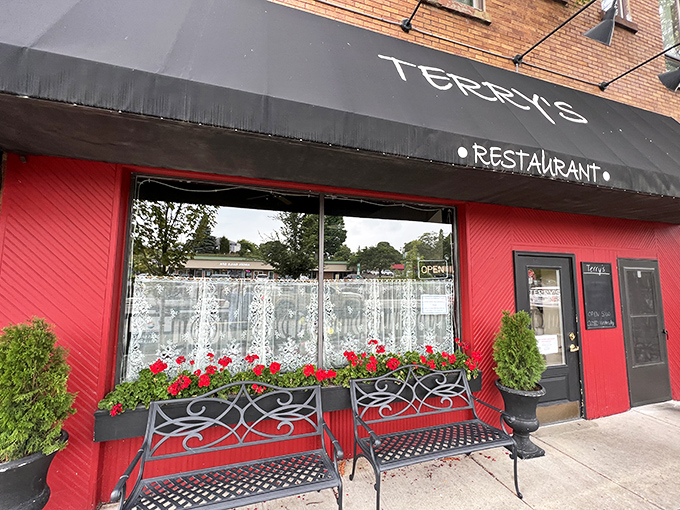 Terry's Restaurant's vibrant red exterior and blooming flower boxes promise comfort food that satisfies both stomach and soul.