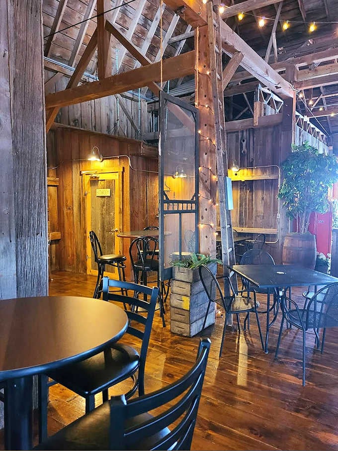 Exposed wooden beams and twinkling lights create a cathedral-like atmosphere where history meets hospitality in this lovingly preserved barn.