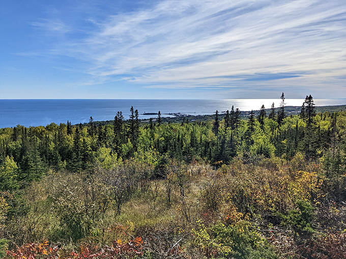 Lake Superior stretches to the horizon like a vast blue canvas, rewarding hikers with panoramic views worth every step of the climb.
