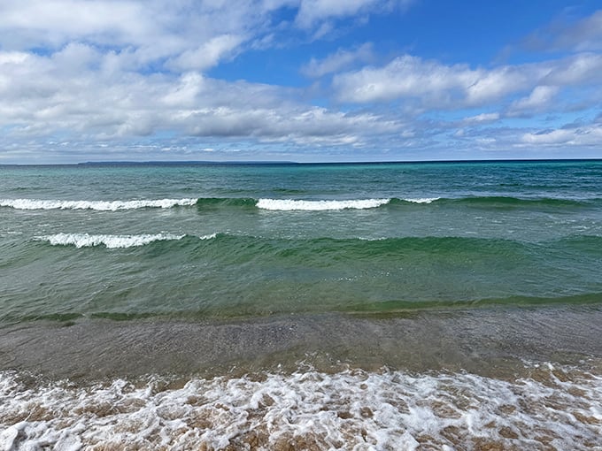 The rhythmic dance of Lake Michigan's waves creates a hypnotic soundtrack that washes away your worries with each gentle crash.
