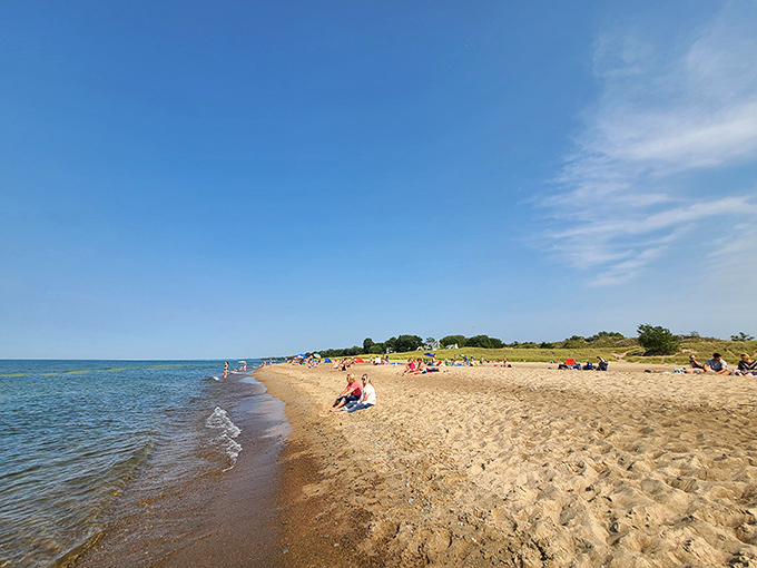 Beachgoers soak up the summer sun along the golden shores of Lake Michigan, where relaxation comes naturally.