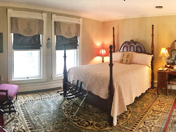 A bedroom that whispers tales of yesteryear, with its four-poster bed, vintage furnishings, and sunlight streaming through elegant window treatments.