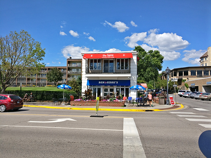 Downtown Wayzata buzzes with charm as Ben & Jerry's ice cream shop beckons visitors for a sweet treat after lakeside adventures.