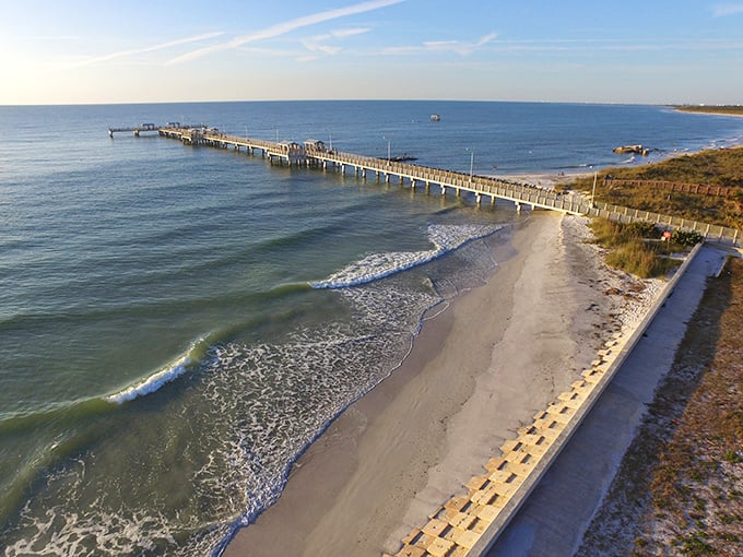 The iconic fishing pier stretches like a runway into the Gulf, where amateur anglers and seasoned fishermen alike cast their hopes into the deep blue.