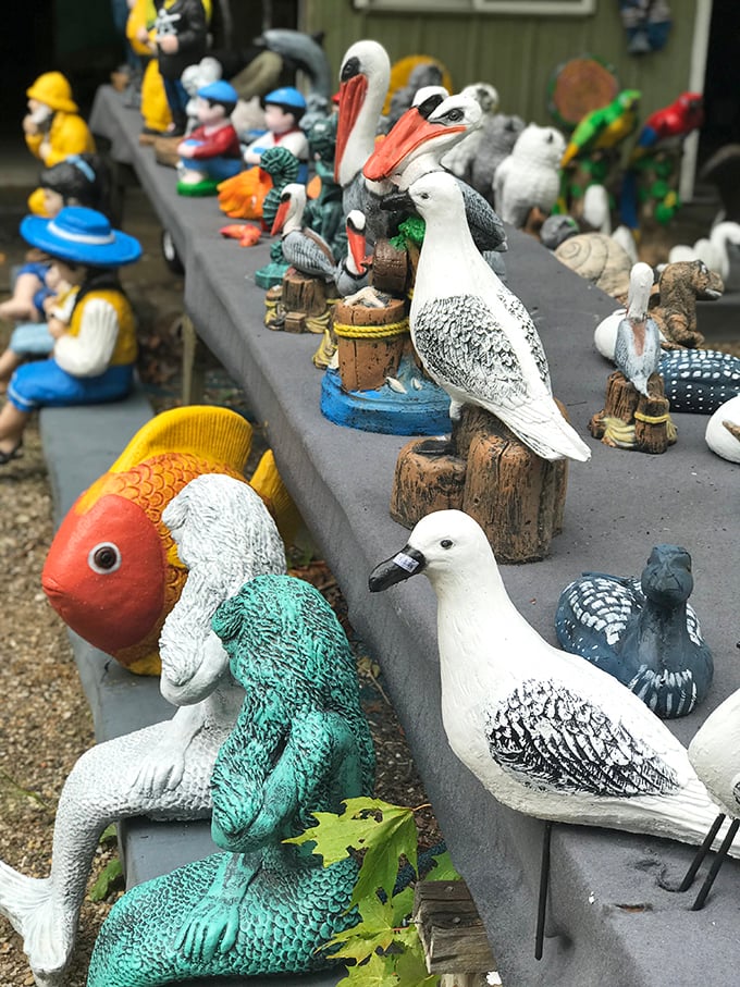 These aren't your average garden gnomes! A collection of birds and figurines that seem to be having quite the waterfront conference.