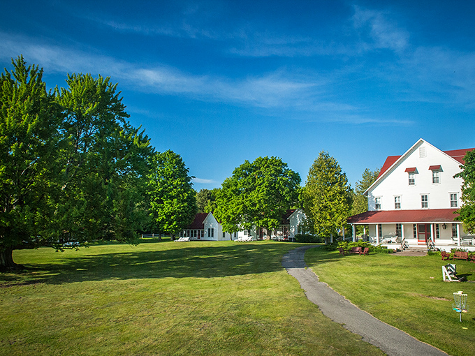 The sprawling grounds invite barefoot wandering, with century-old trees providing perfect shade spots for afternoon naps or morning coffee.