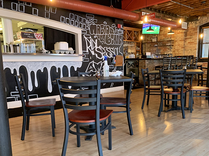 The unassuming exterior of Big O' Cafe beckons pizza lovers with its simple circular sign &ndash; a secret entrance to flavor paradise below street level.