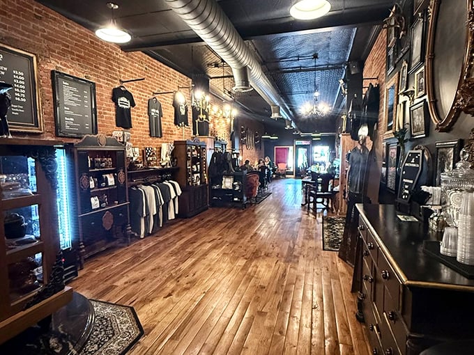 Exposed brick meets dark elegance inside, where vintage frames and ornate mirrors create a hauntingly beautiful atmosphere.