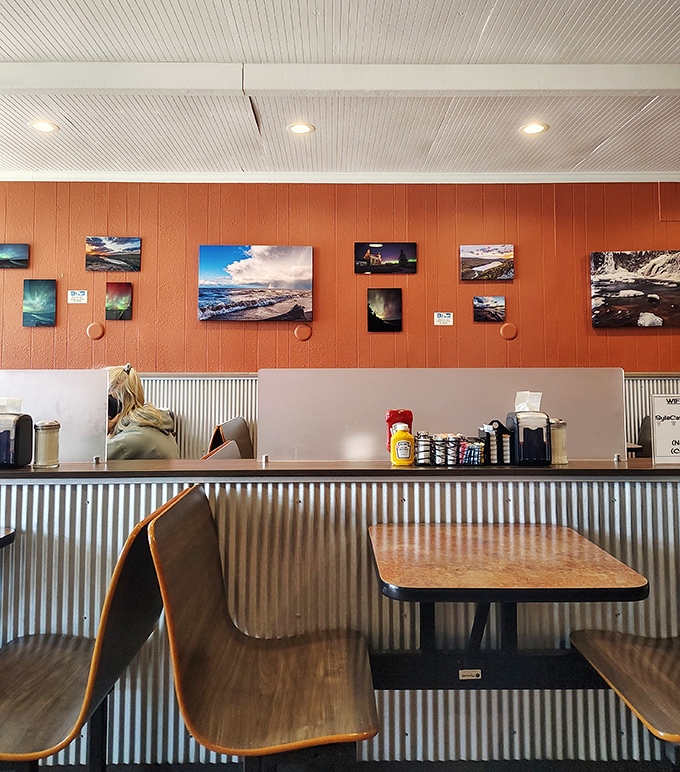 Simple corrugated metal wainscoting and local photography create an unpretentious atmosphere where the food, not the decor, takes center stage.