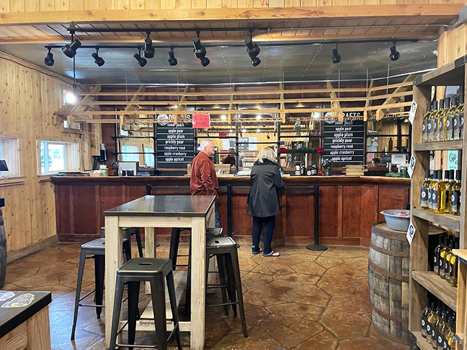 The rustic wooden interior of the taproom welcomes visitors with warm lighting and a selection of hard ciders that would make any apple blush with pride.