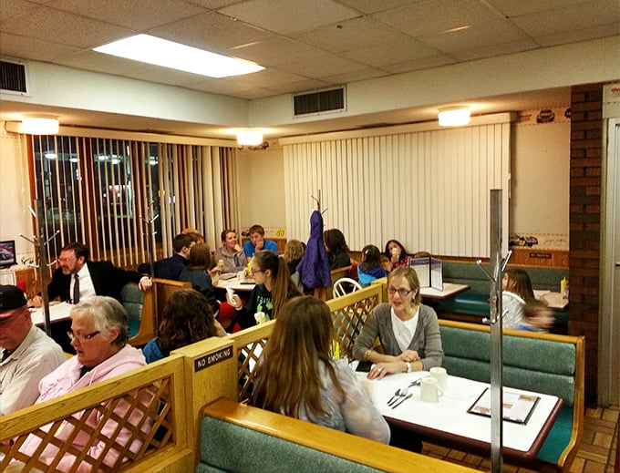 Cozy wooden booths with lattice dividers create the perfect pit stop for families and regulars alike in this racing-themed dining haven.