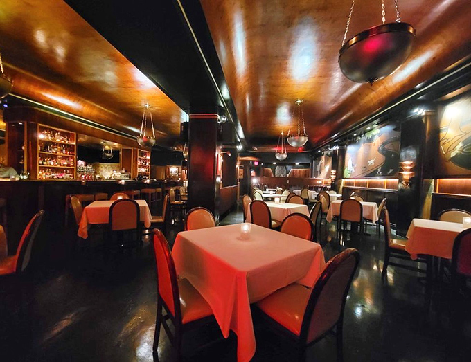 Warm mahogany walls and gleaming surfaces create a cocoon of vintage luxury where every table feels like the best seat in the house.