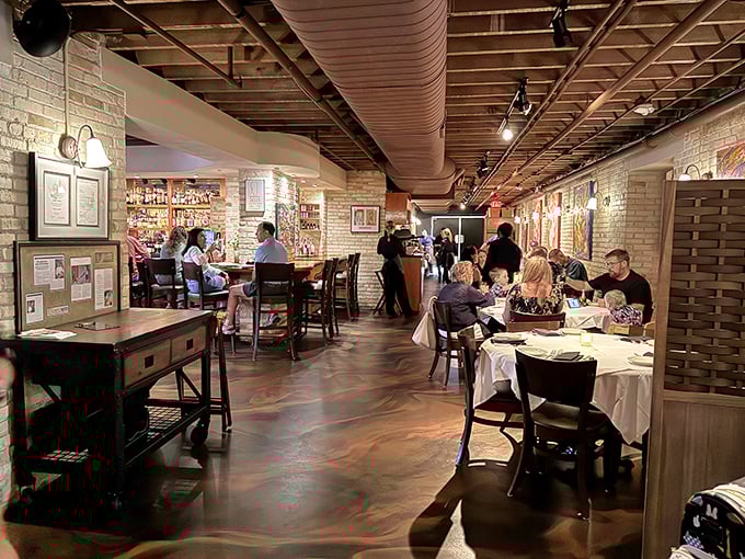 Exposed brick walls and warm lighting transform what was once institutional space into an intimate dining haven.