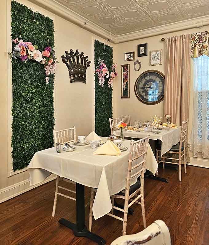 Elegance meets fantasy in this dining room where green wall panels, floral accents, and a crown motif create a royal tea party atmosphere.