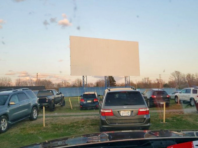 The blank canvas awaits its nightly transformation, standing tall against the fading daylight like a sentinel of cinematic adventures to come.