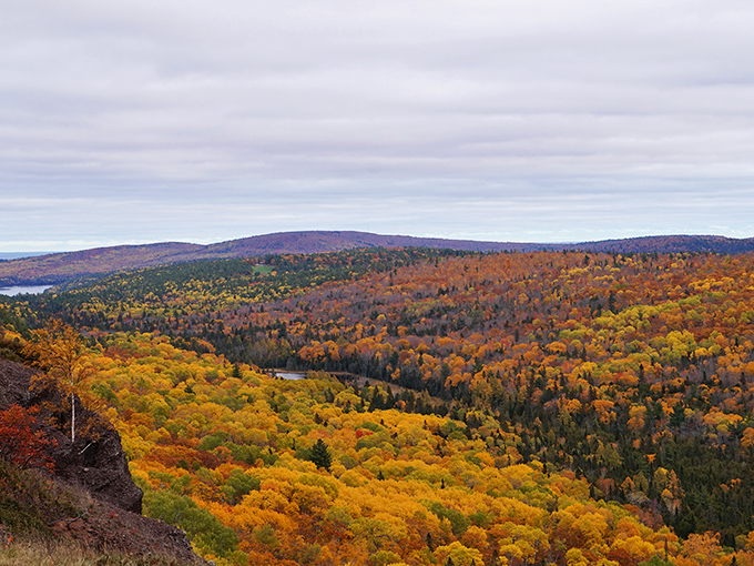A tapestry of fall colors blankets the Keweenaw Peninsula, creating a patchwork quilt of amber, crimson, and gold that stretches to the horizon.