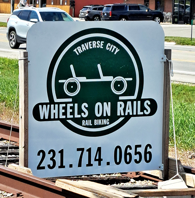 The iconic Wheels on Rails sign welcomes adventurers to Traverse City's unique attraction, promising railroad thrills without the locomotive.