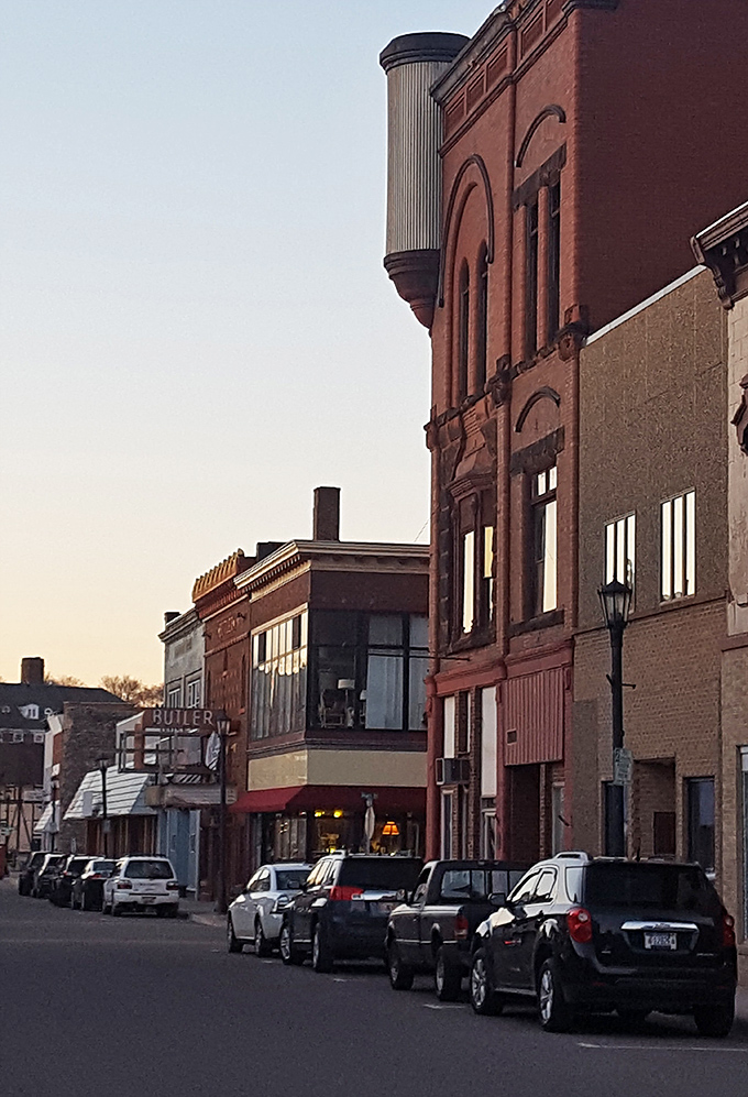 Brick facades and vintage architecture create a living museum effect, inviting visitors to explore at a leisurely pace.