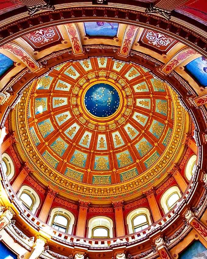 Look up! The Capitol's stunning rotunda features hand-painted details and a glass floor that reveals a starry sky design. The meticulous restoration preserves the building's 19th-century grandeur.