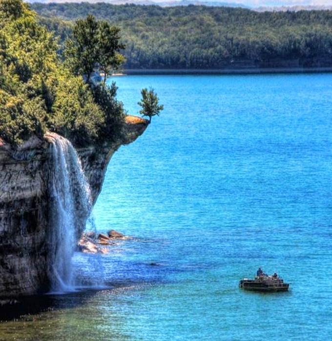 The waterfall appears to emerge directly from the cliff face, like Mother Nature decided to install a luxury shower.