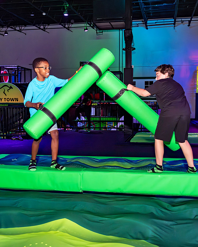 Modern gladiators face off with foam weapons on the battle beam &ndash; friendship temporarily suspended for bouncy combat glory.
