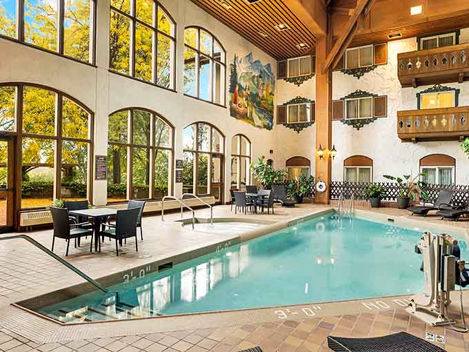 The indoor pool area offers year-round swimming under soaring windows, with Alpine murals and wooden beams completing the European ambiance.