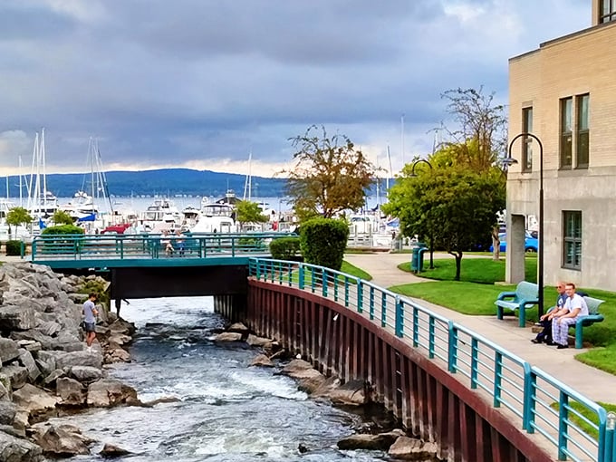 Bayfront Park's winding walkway invites leisurely strolls alongside rushing waters, with boats bobbing in the harbor just beyond.