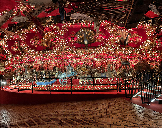 The world's largest indoor carousel spins in perpetual motion, its 269 fantastical creatures bathed in red light and thousands of twinkling bulbs.