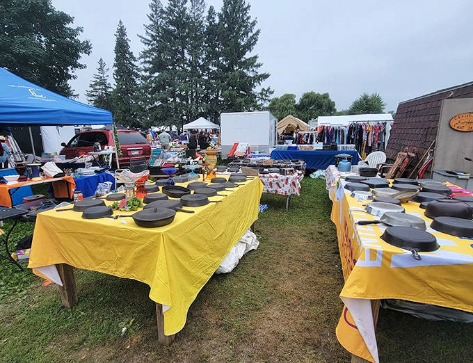 Cast iron heaven: Seasoned skillets and Dutch ovens wait for new kitchens to call home, each bearing the patina of countless meals lovingly prepared.