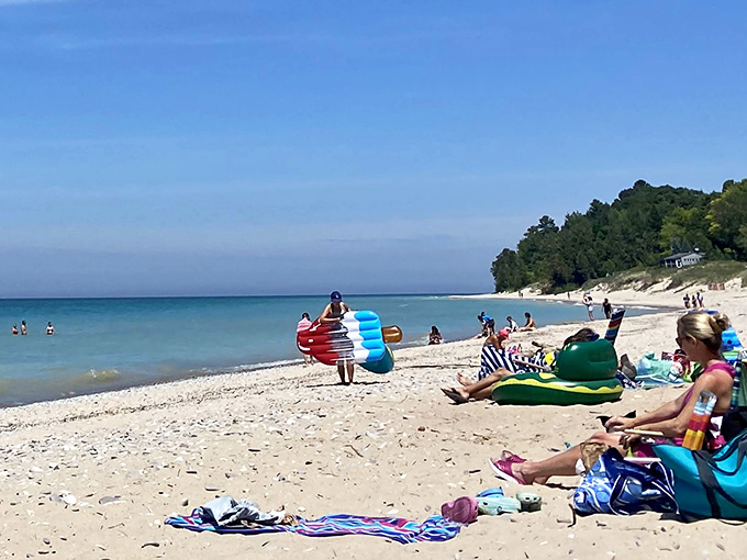 Beach day bliss! Colorful floats and sun-seekers dot the shore at Christmas Cove, Michigan's answer to tropical paradise.