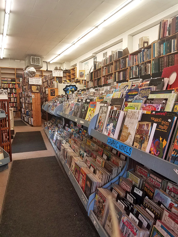 The graphic novel section at Midway Books is like a colorful roadmap to alternate universes. Browse long enough and you might just find your childhood self waiting there.