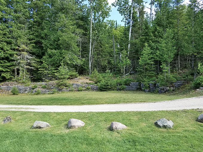 Forest Edge: Nature's perfect balance of manicured lawn meeting wild forest, with ancient limestone formations peeking through – Mother Nature's own landscaping masterpiece.