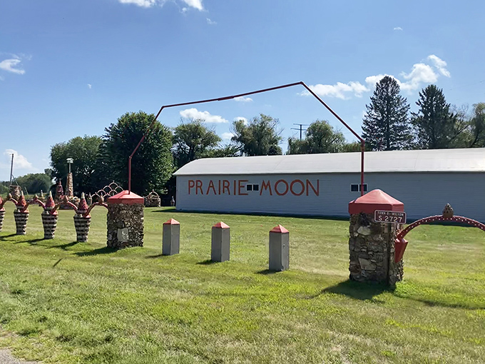 Prairie Moon welcomes visitors with its distinctive sign and stone pillars, standing like sentinels guarding a realm of concrete dreams.