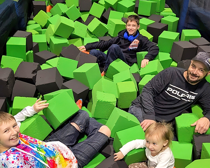 Dive into a colorful abyss of foam blocks where landing becomes an art form and extraction qualifies as a workout.