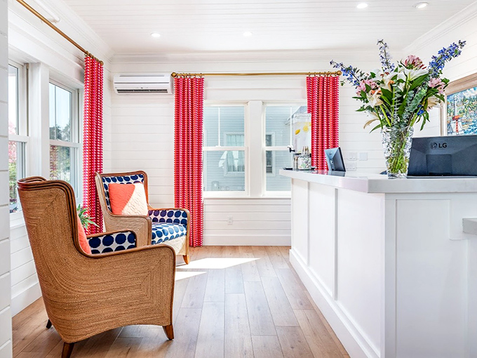Front Desk: Crisp white walls meet pops of navy and coral in this reception area where check-in comes with cookies and genuine smiles.