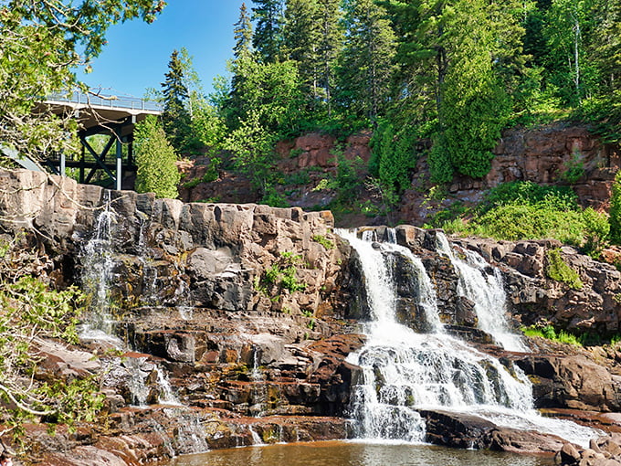 Gooseberry Falls cascades in elegant tiers, nature's own multi-level fountain where visitors gather like pilgrims at a watery shrine.