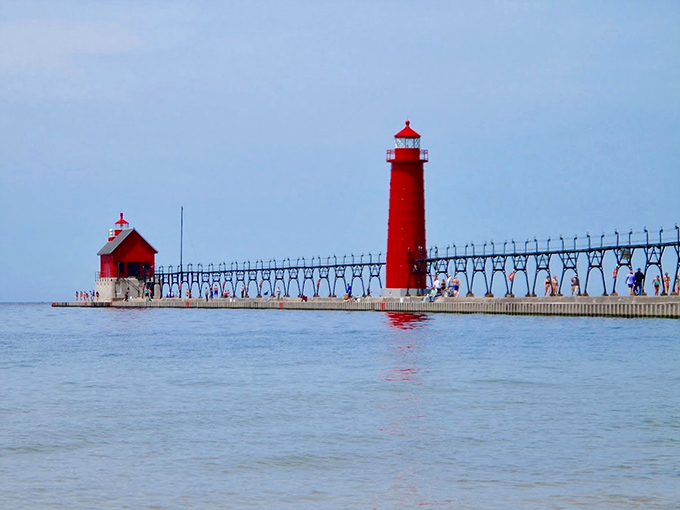 The iconic red lighthouse creates a striking contrast against Lake Michigan's blue canvas, drawing photographers and dreamers alike.