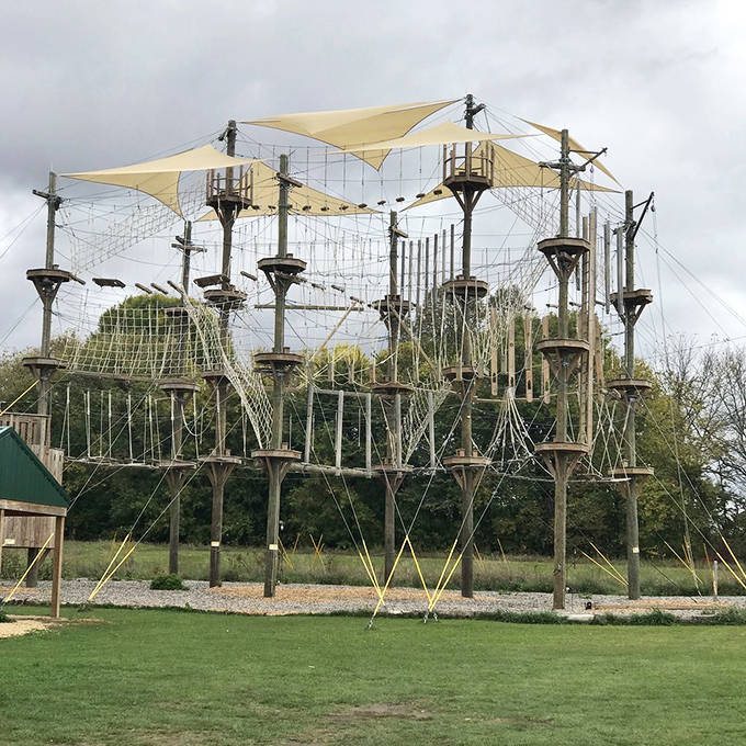 Not your average playground! Kerfoot's aerial obstacle course stands like a wooden castle in the sky, promising adventure for those brave enough to climb.
