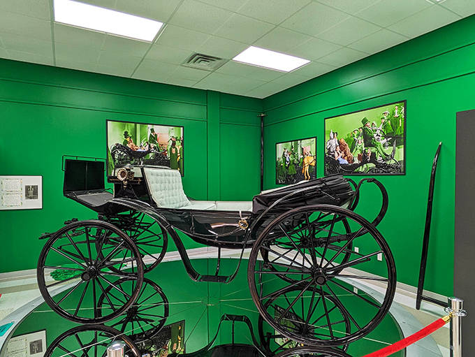 The iconic "Horse of a Different Color" carriage sits majestically against emerald green walls, just as magical as when it clip-clopped through the Emerald City.