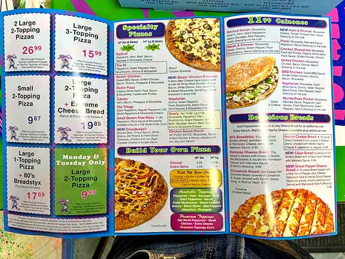 The menu bursts with radical options from classic pies to specialty creations like "The 85" and "Kickin' Chicken" &ndash; each one a tasty tribute to the decade of excess.