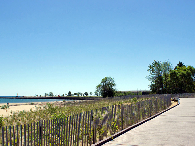 Wooden boardwalks and protective dune fencing preserve the natural ecosystem while providing easy beach access for visitors of all abilities.
