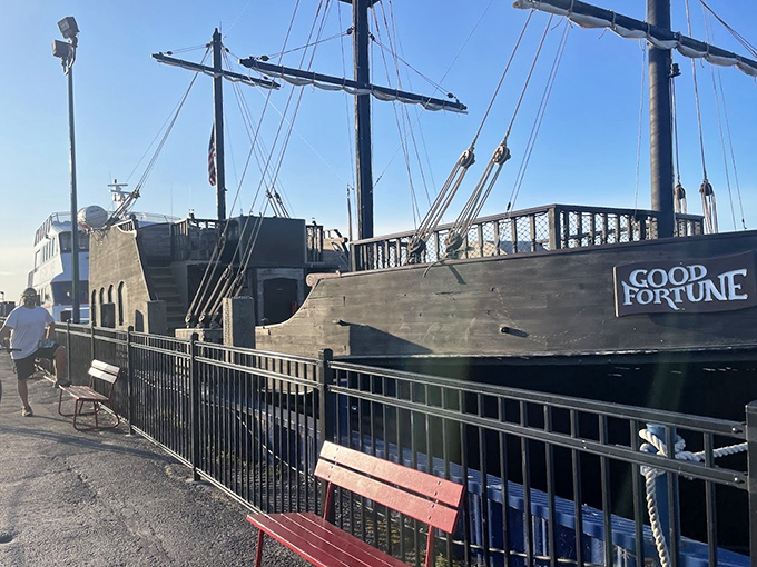Docked and ready for adventure, the Good Fortune's authentic wooden hull and towering masts create a silhouette straight from the golden age of piracy.