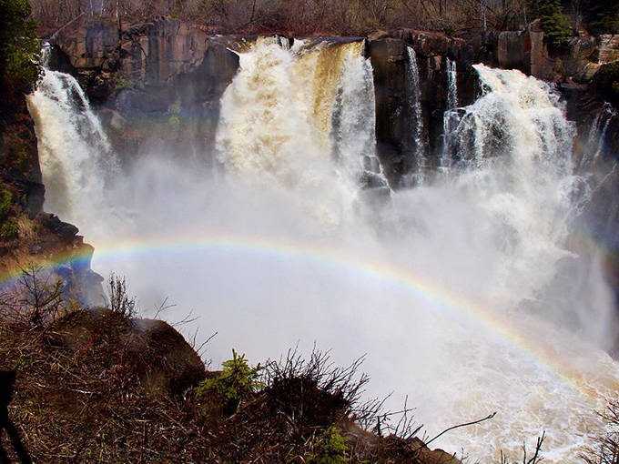 Mother Nature's light show: Sunlight dancing through the mist creates ephemeral rainbows, adding magic to an already spectacular waterfall view.