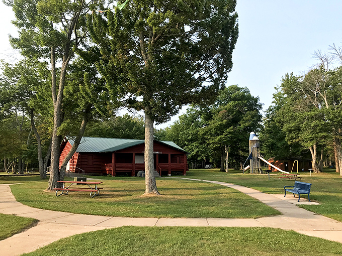 Sherman Park's rustic log cabin stands sentinel among towering trees, offering a perfect blend of wilderness comfort just minutes from downtown.