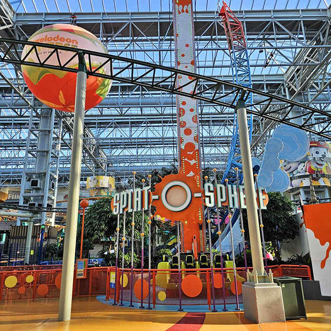 The Splat-O-Sphere ride lifts thrill-seekers high above the park floor, proving gravity and good sense are merely optional in this indoor playground.