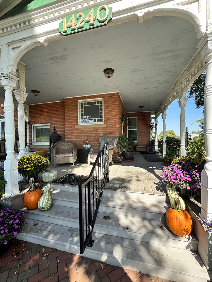Stairs: The inviting front porch, adorned with seasonal pumpkins and vibrant flowers, offers a warm embrace before you even step inside.